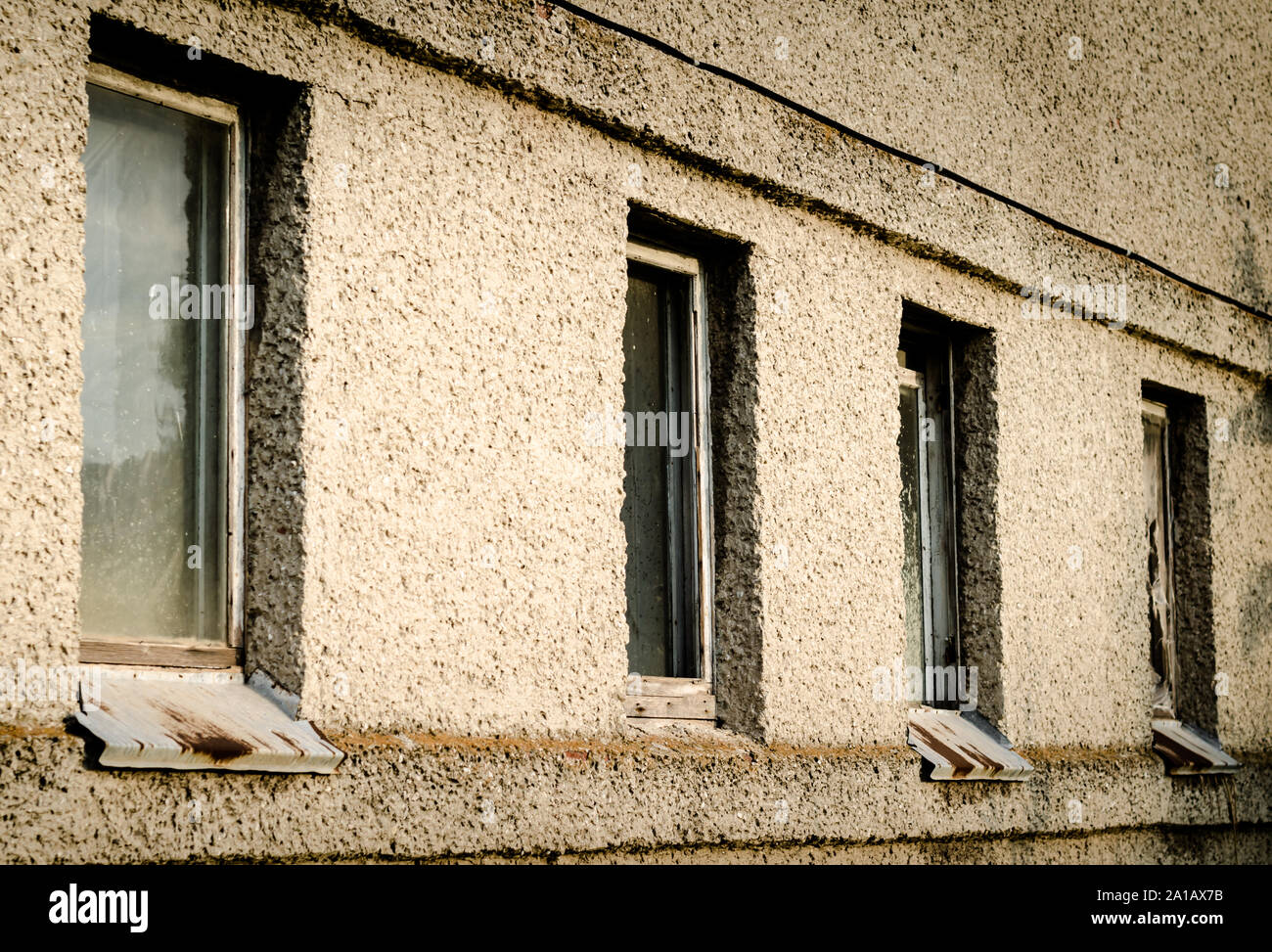 old dirty wall of a building with windows Stock Photo - Alamy