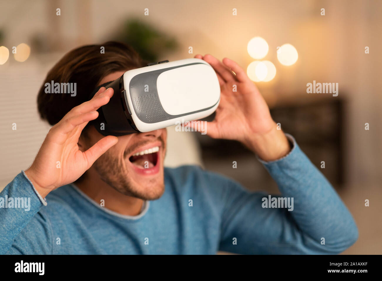 Millennial Guy Using Virtual Reality Glasses Playing Videogame At Home ...