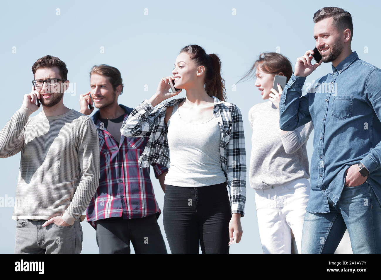 group of students talking on their smartphones Stock Photo - Alamy