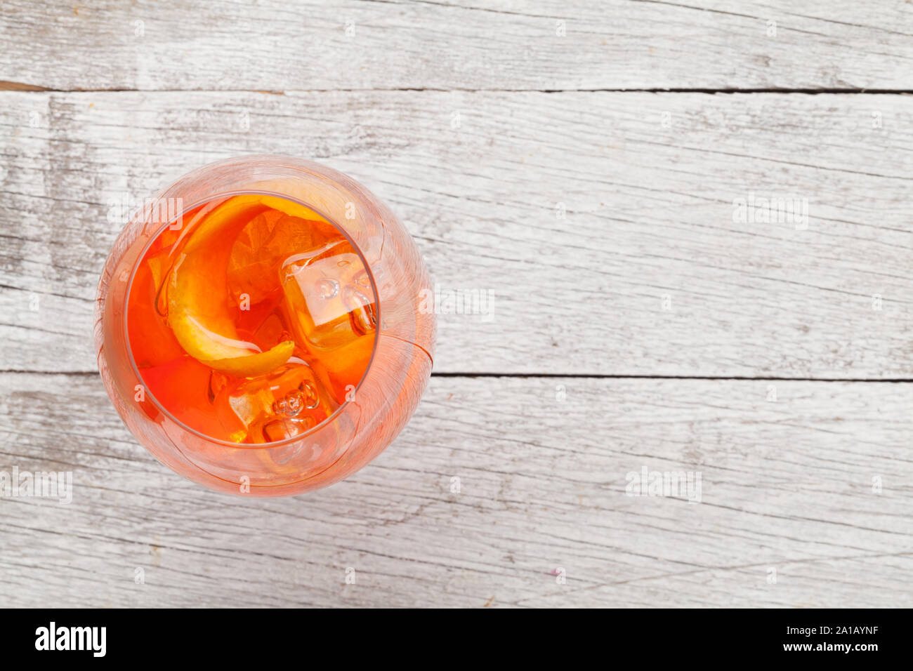 Classic aperol spritz cocktail on white wooden table. Top view with ...