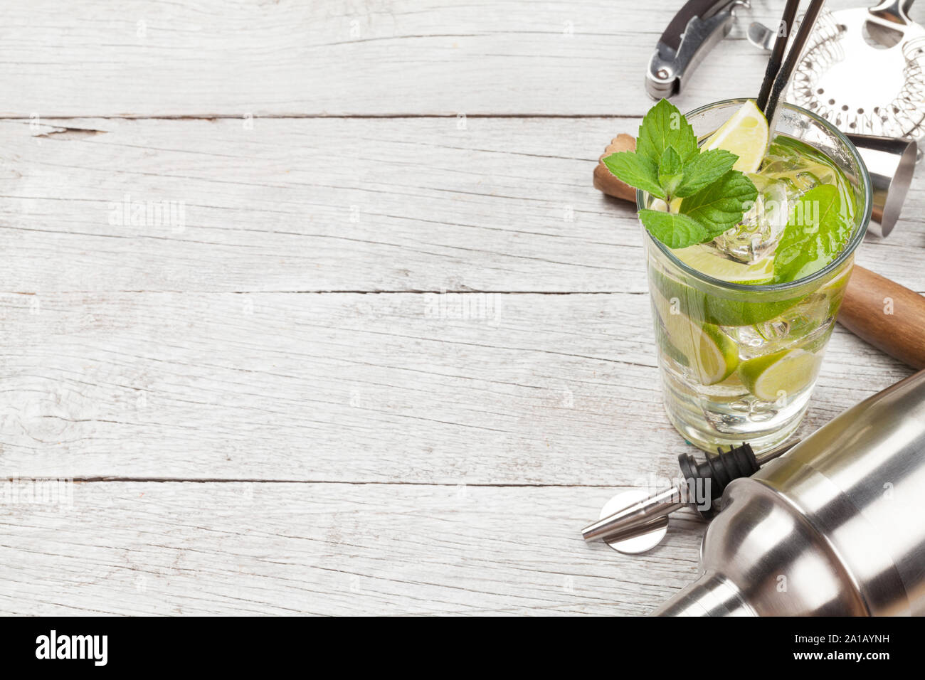 Cocktail utensils. Set of bar tools and mojito cocktail on wooden table ...