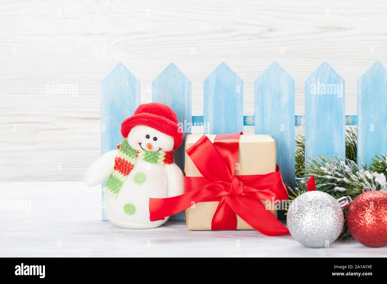 Christmas snowman toy, gift box and fir tree branch. Xmas greeting card ...