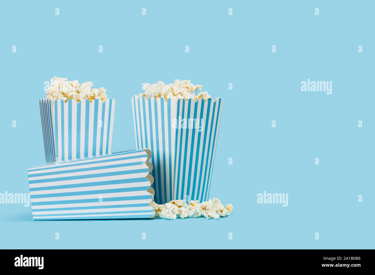Popcorn in buckets on a light blue background Stock Photo - Alamy