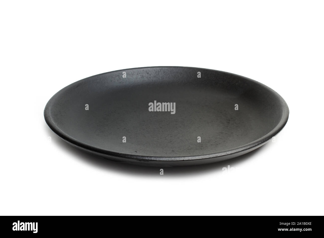 Black round dish on a white background Stock Photo - Alamy