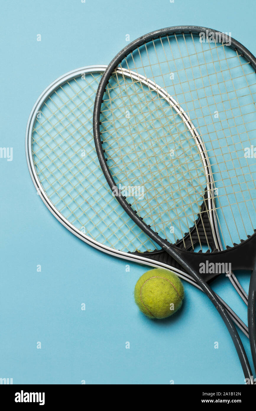 Vintage tennis rackets on a light blue background Stock Photo - Alamy