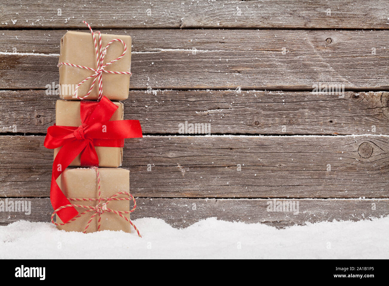 Christmas card with xmas gift boxes in front of wooden wall. With space ...