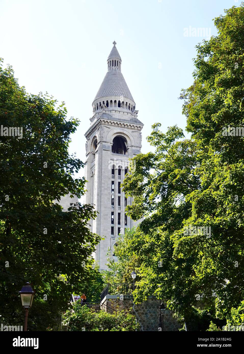 Bell tower of the Basilica of Sacre Coeur as seen through the trees of ...