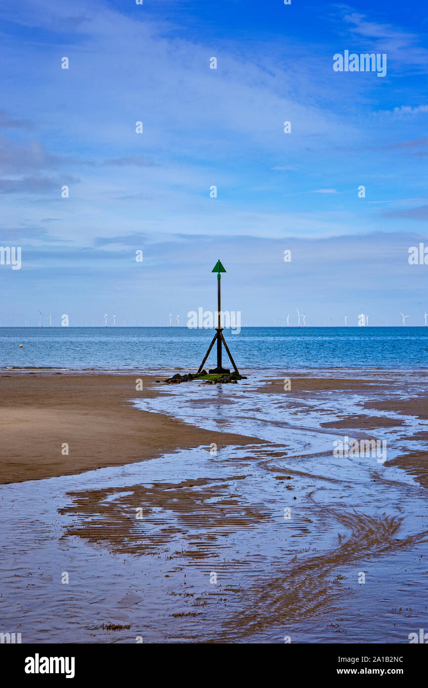 Tidal marker on beach in North Wales UK Stock Photo - Alamy