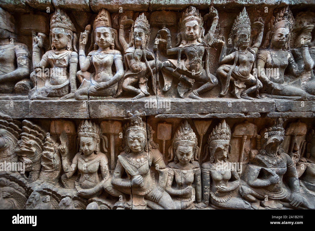 Carved bas-relief design murals on a temple at Angkor Wat complex ...