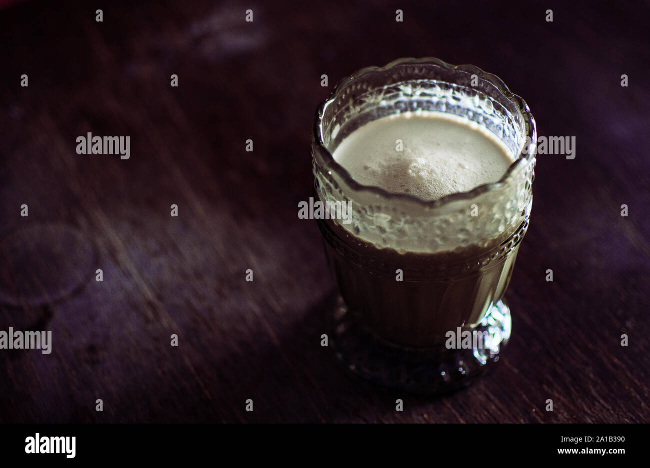 Latte coffee in an unusual glass with antique patterns. American in ...
