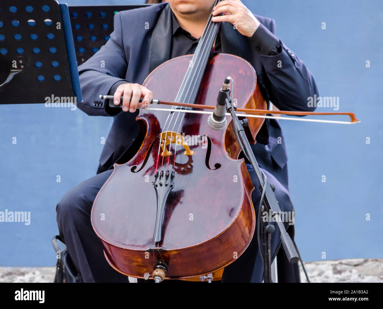 musician in blue suit playing the cello Stock Photo - Alamy