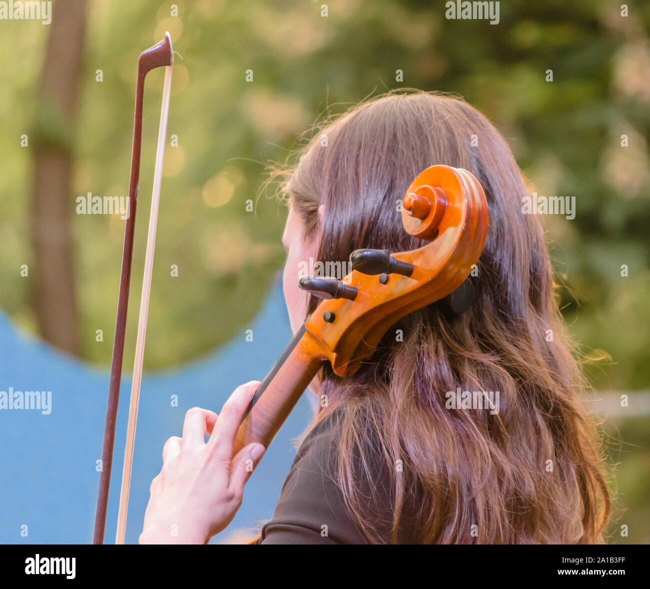 young brunette girl playing the cello on the street Stock Photo - Alamy