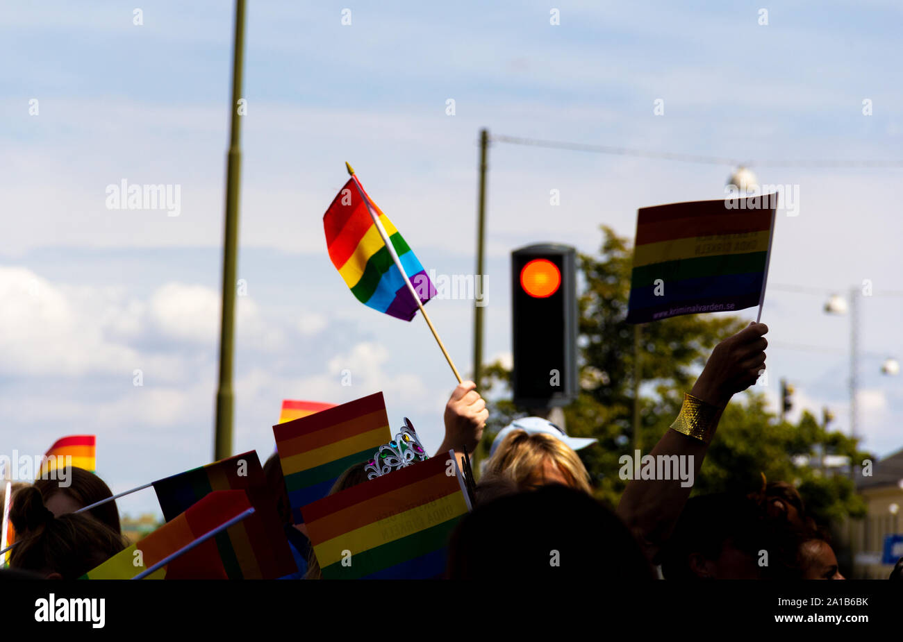 Hands waving the rainbow-colored pride flag during the 2019 pride ...