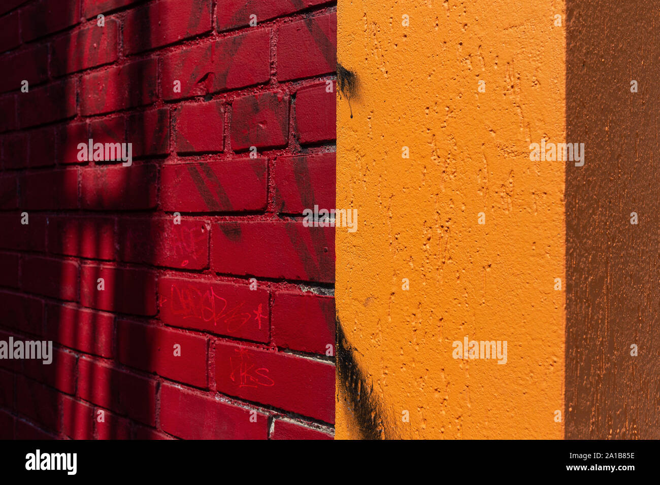 Red brick wall and yellow wall photographed in Toronto Stock Photo - Alamy