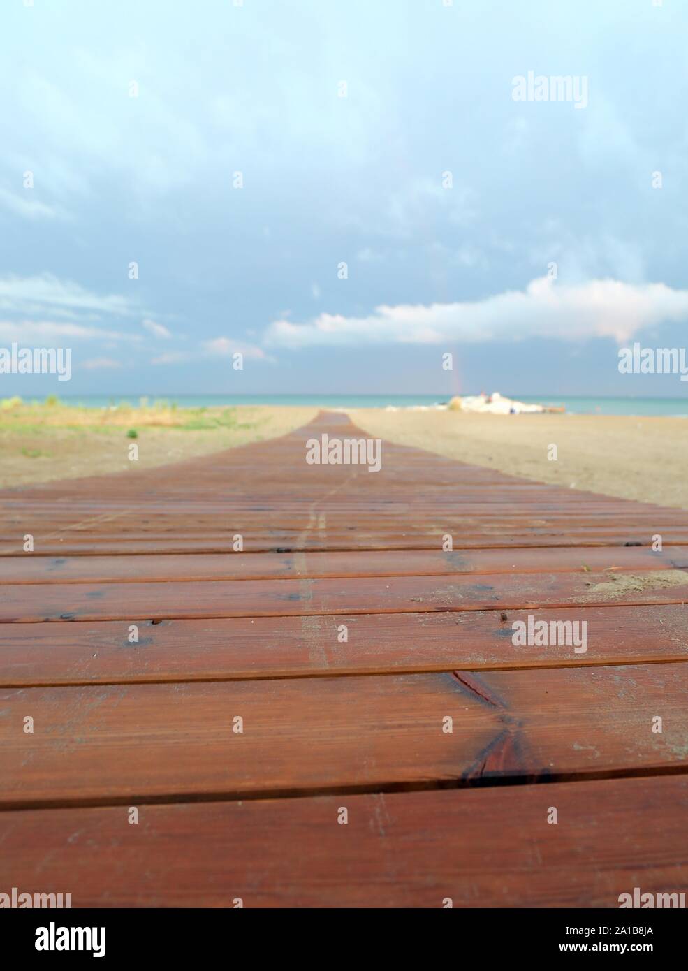 wooden walkway on the beach towards the sea after the flood Stock Photo ...