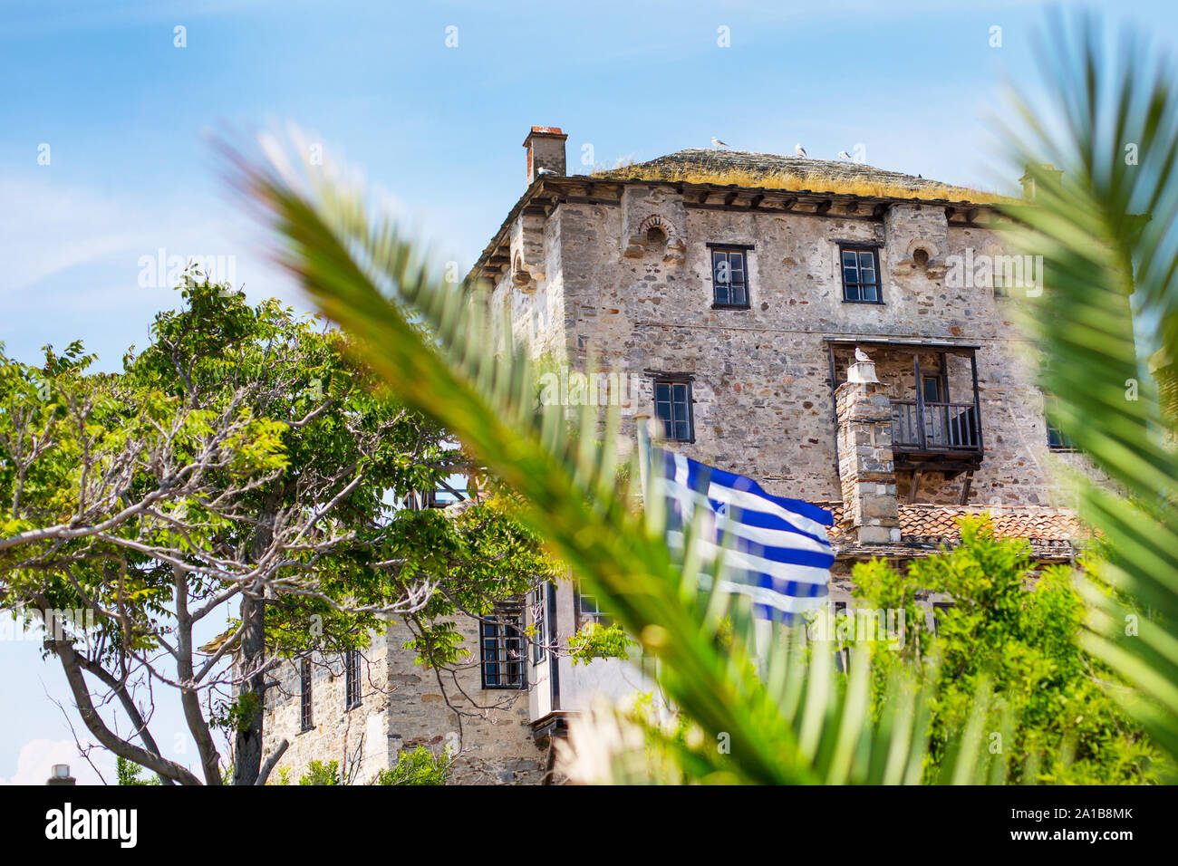 Ancient Ouranoupolis Tower on Athos peninsula in Halkidiki, flag of ...