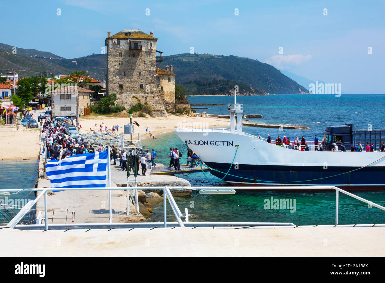 Ouranoupolis , Greece - June, 1, 2015: Tourists descend from ship under ...