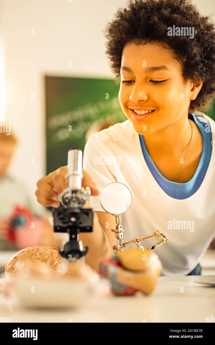 Positive delighted brunette boy studying interesting microbiology Stock ...