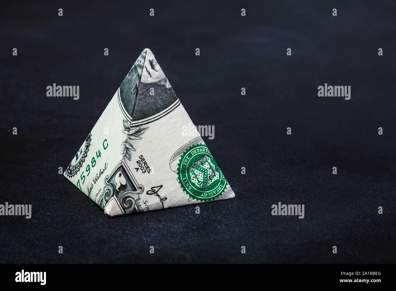 Origami dollar pyramid Stock Photo - Alamy