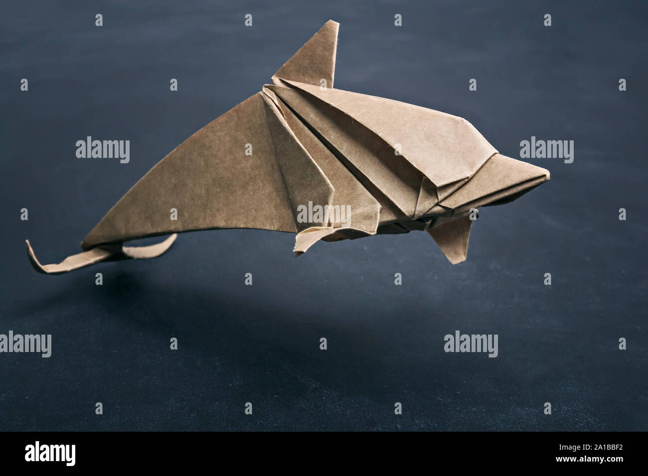 Dolphin origami of kraft paper Stock Photo - Alamy