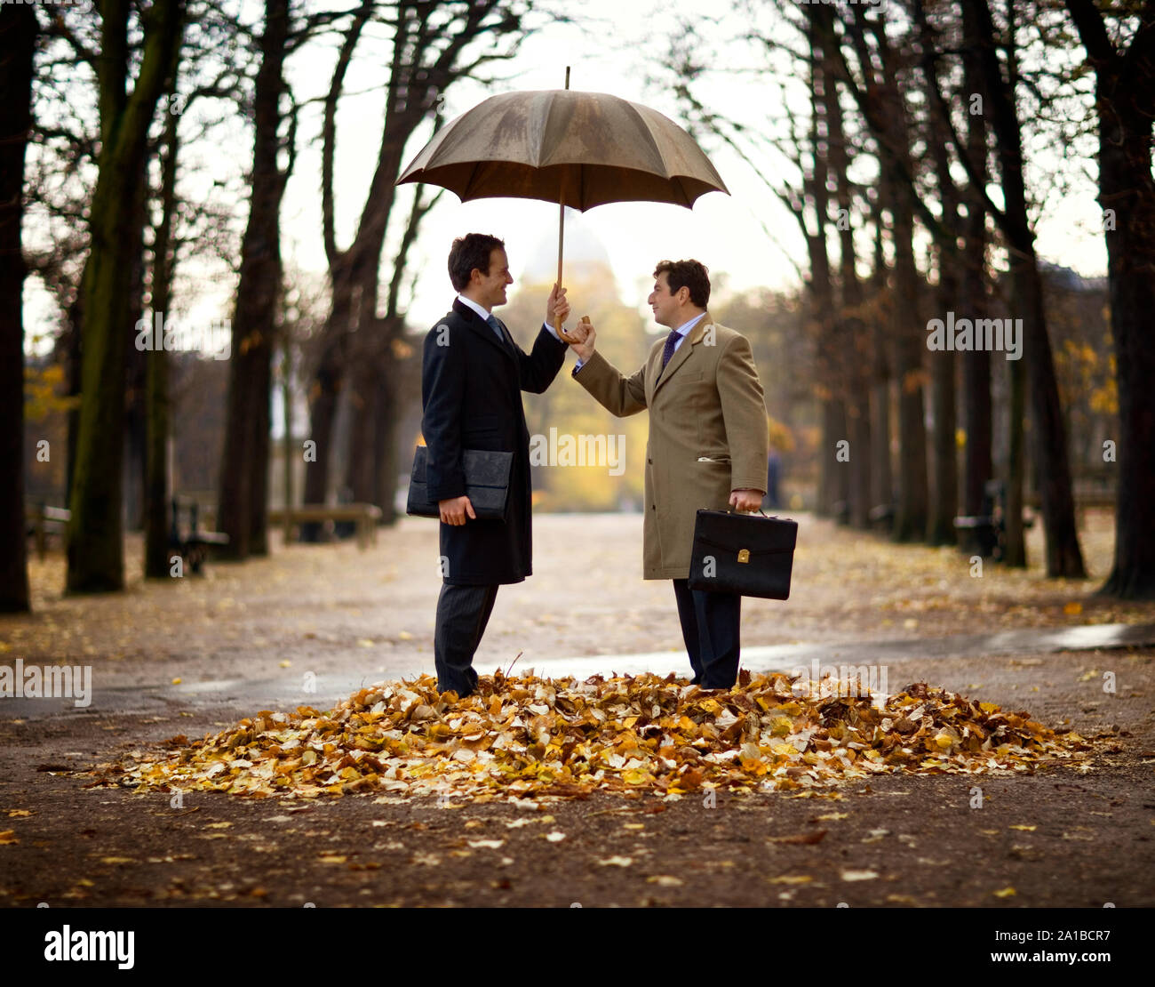 People Sharing An Umbrella