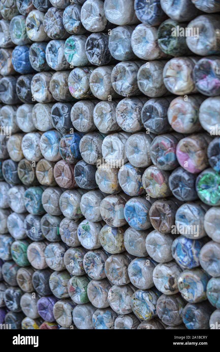 Wall made of recycled plastic bottles filled with trash Stock Photo - Alamy