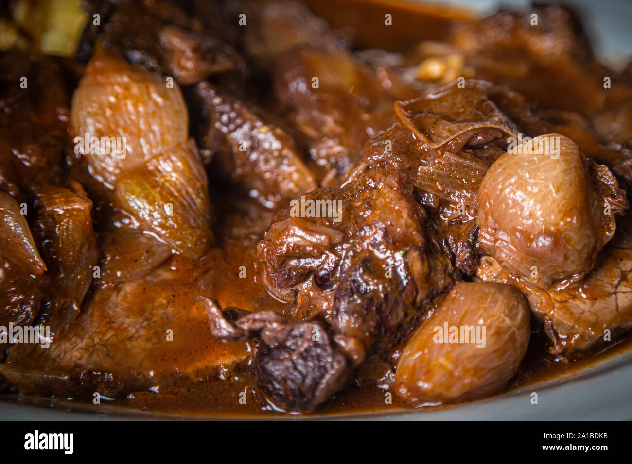 Braised beef with onion and corn polenta Stock Photo - Alamy