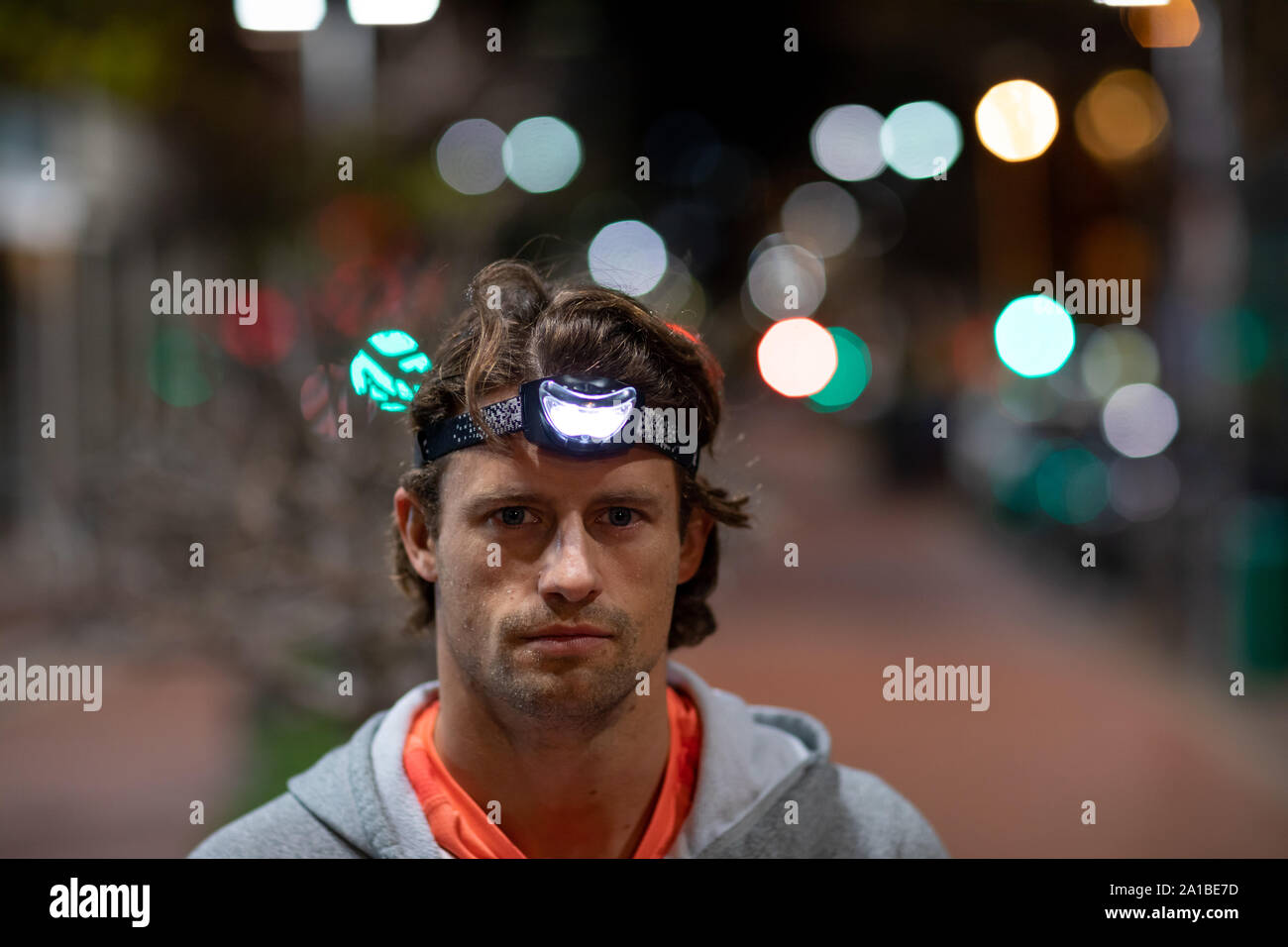 Young man with headlamp on Stock Photo - Alamy