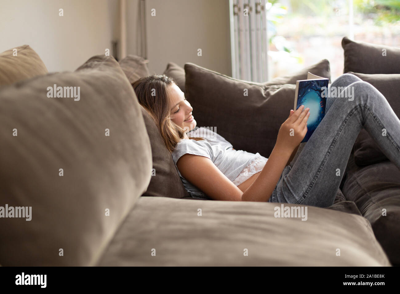 Young girl enjoying time at home Stock Photo - Alamy