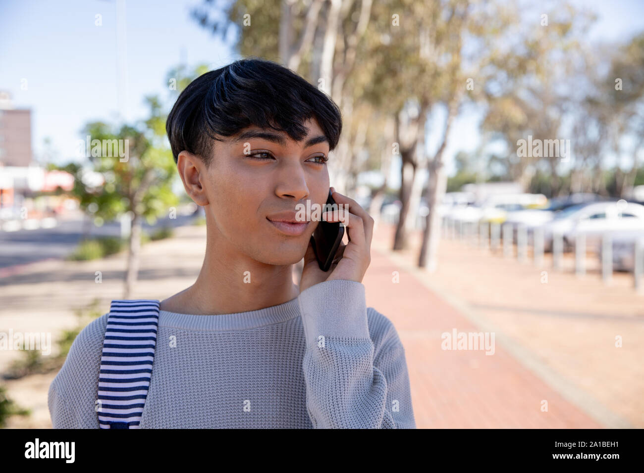 Using smartphone young transgender hi-res stock photography and images ...