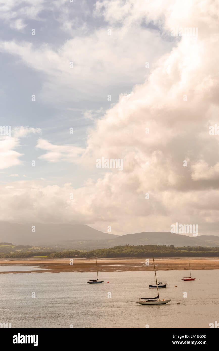 The Menai Strait at Beaumaris. Boats are moored in the Strait at low ...