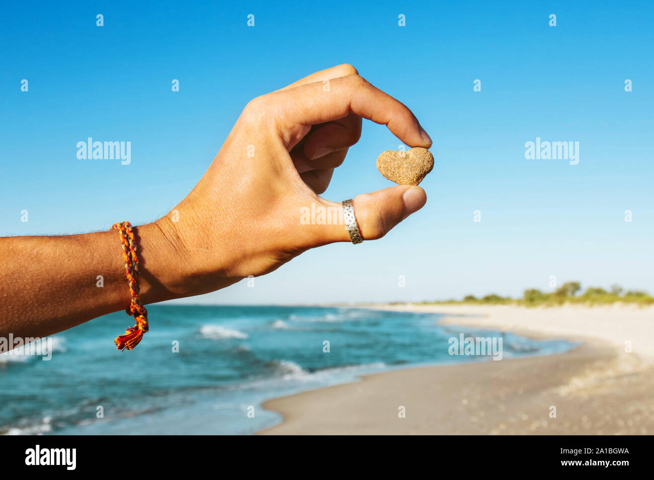 Hand holding stone beach hi-res stock photography and images - Alamy
