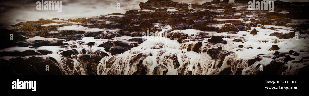 View of water through rocks Stock Photo - Alamy