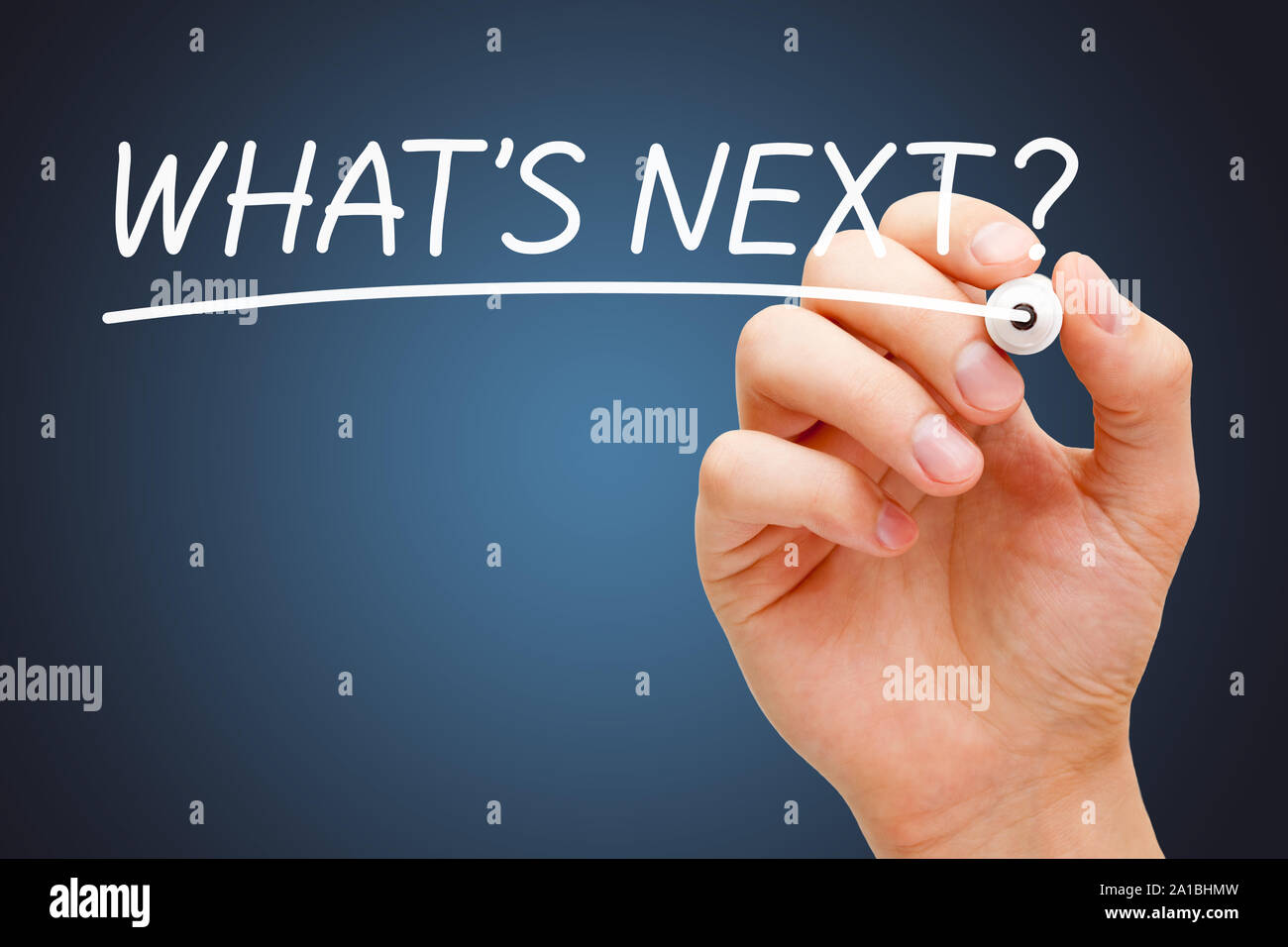 Hand writing What's Next? with white marker on transparent wipe board ...
