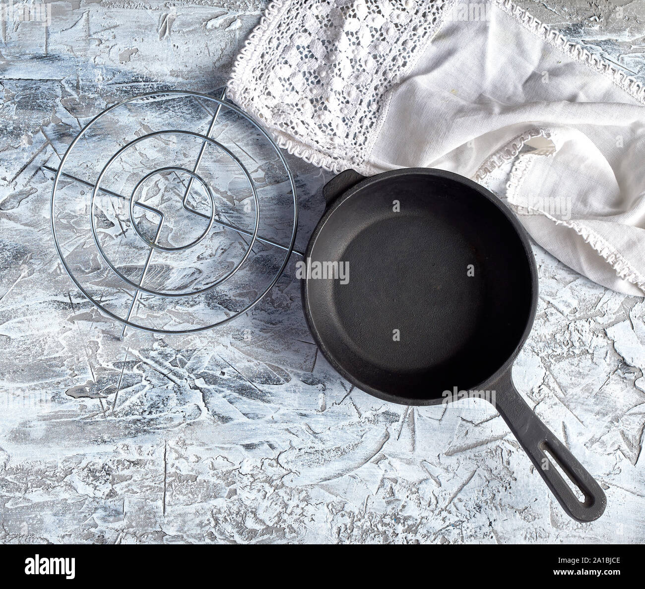 new empty frying pan with a handle on a white background, top view ...