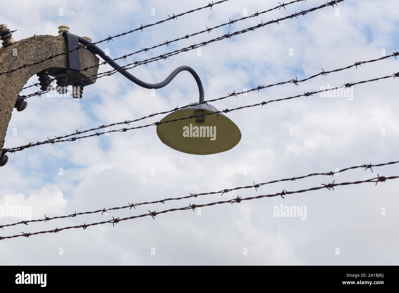 Barbed wire and lantern on a pole Stock Photo - Alamy