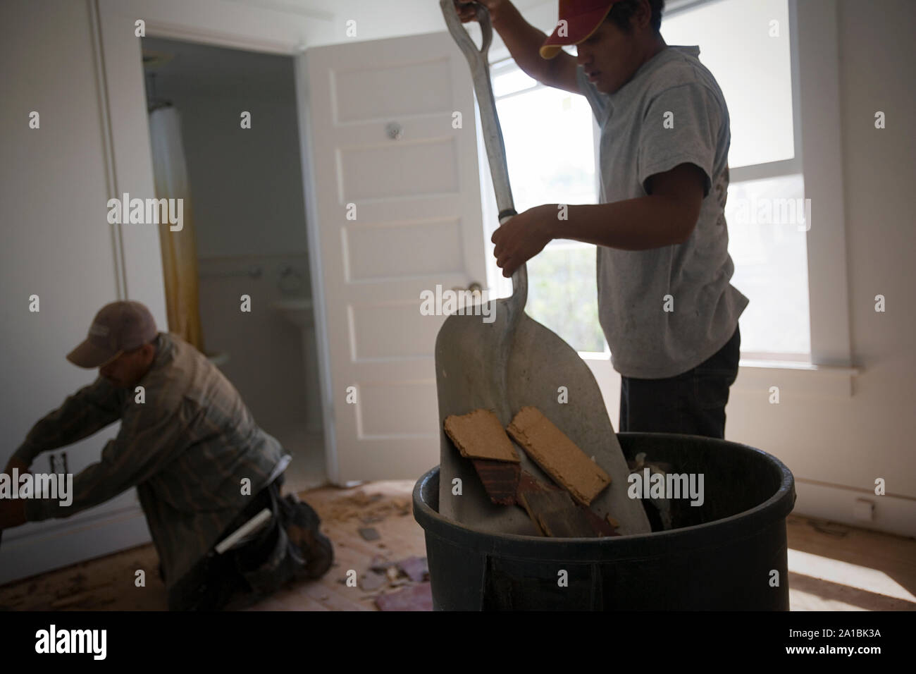 Two male builders working inside a room in a house Stock Photo - Alamy
