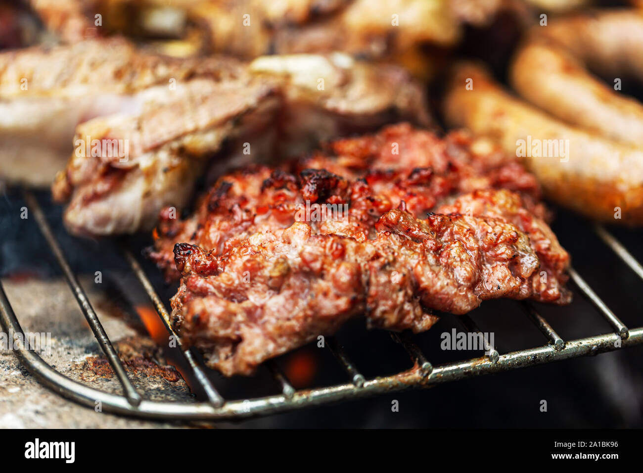 Barbeque grill mixed meat cooking on open air Stock Photo - Alamy
