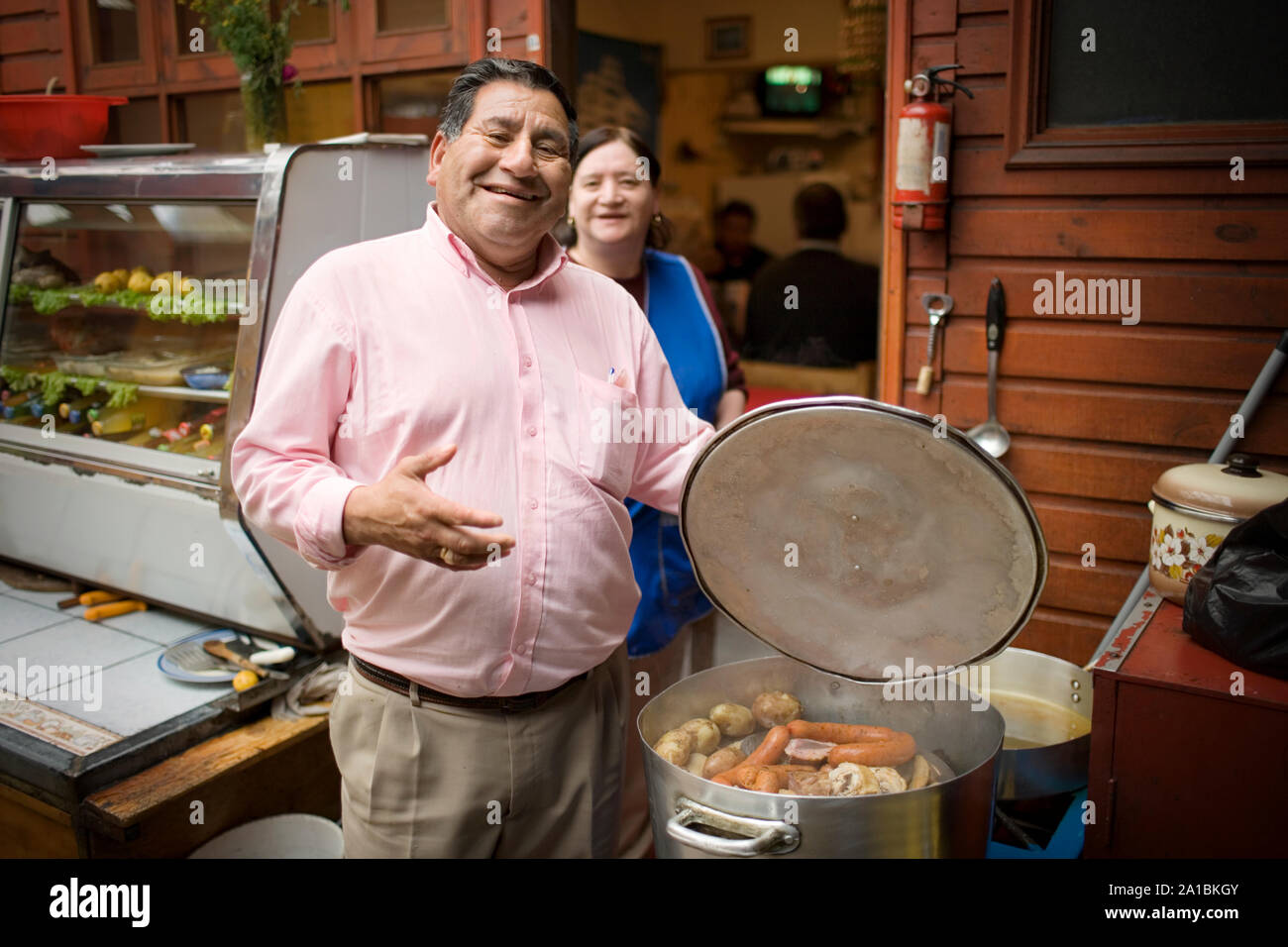 Portrait of a mature man showing a pot of food Stock Photo - Alamy