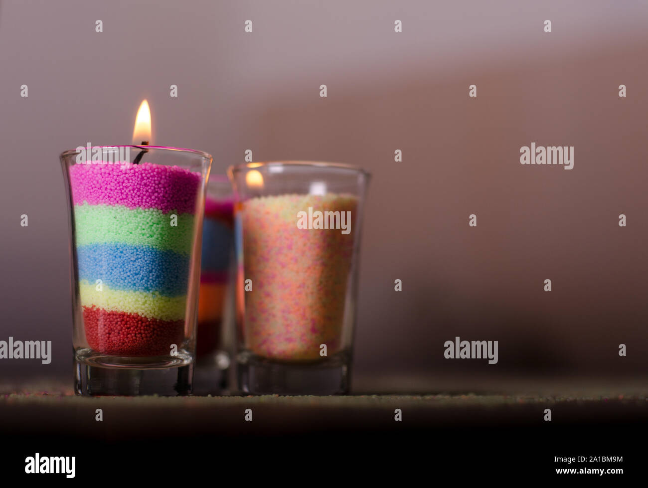 Three Homemade candles from colored granulated wax in a glasses Stock ...