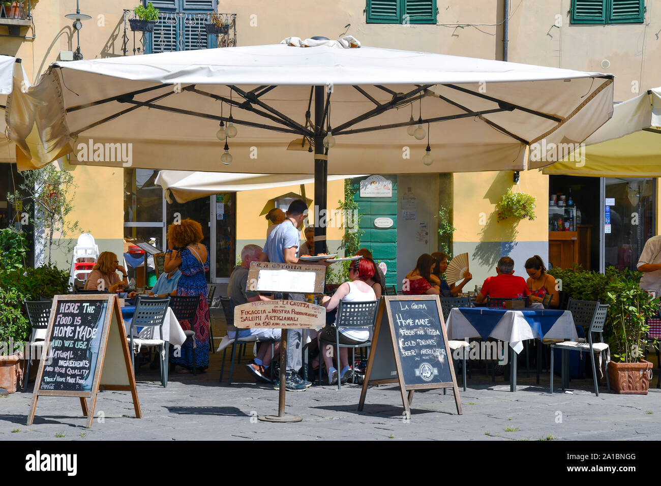 Outdoor restaurant in Piazza dell'Anfiteatro in the centre of Lucca ...