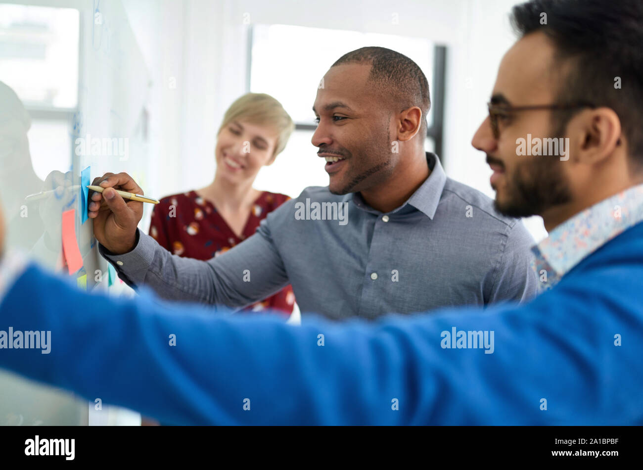 Marketing team collaborating whiteboard sticky hi-res stock photography ...