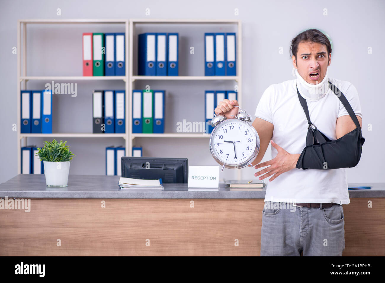 Clinic reception counter and young patient Stock Photo - Alamy