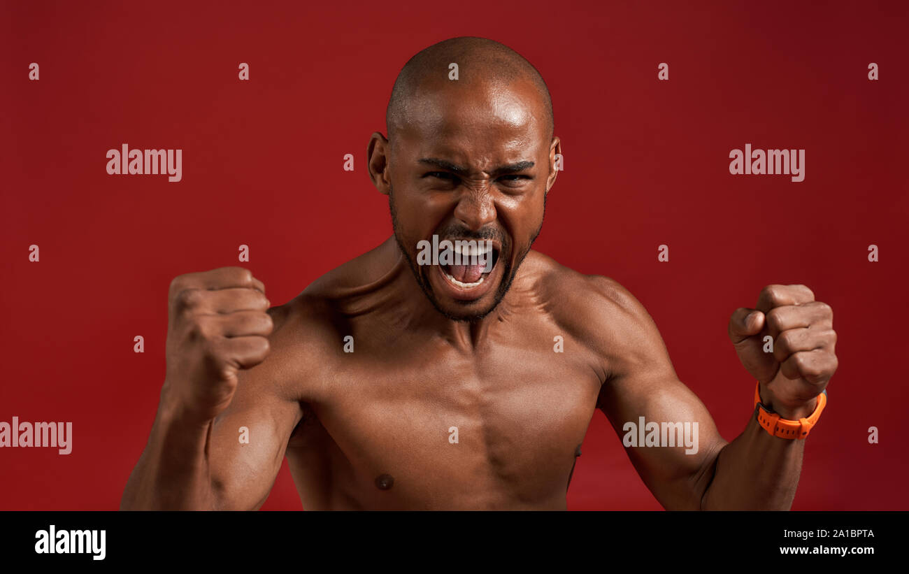 Stronger with every new day. Close up portrait of african man screaming ...
