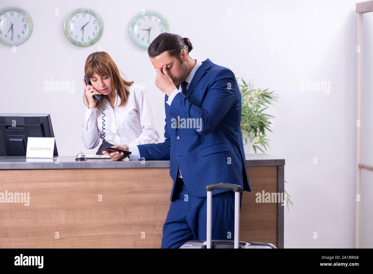The young businessman at hotel reception Stock Photo - Alamy