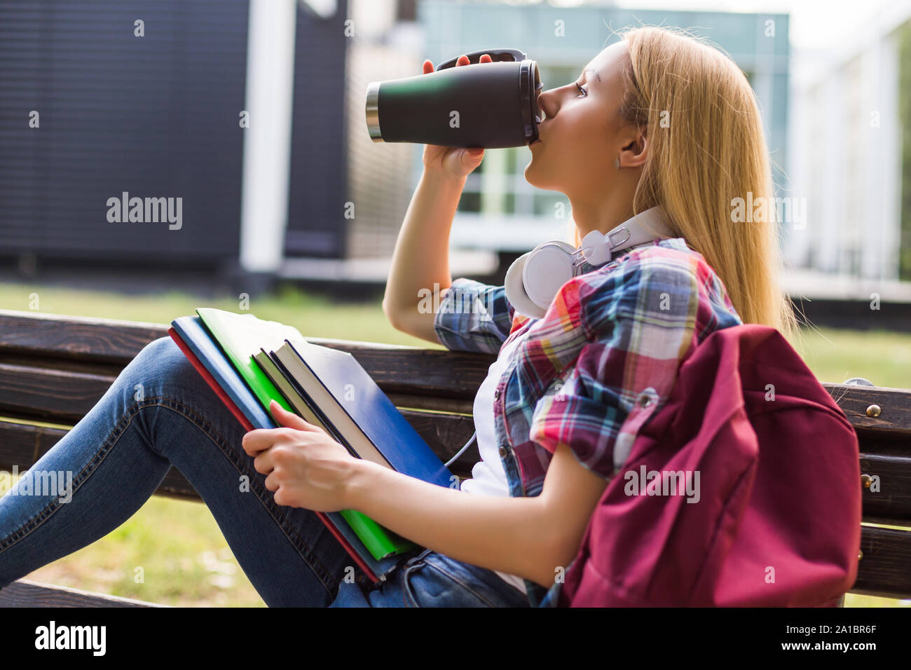 Female student drinking coffee outdoor Stock Photo - Alamy