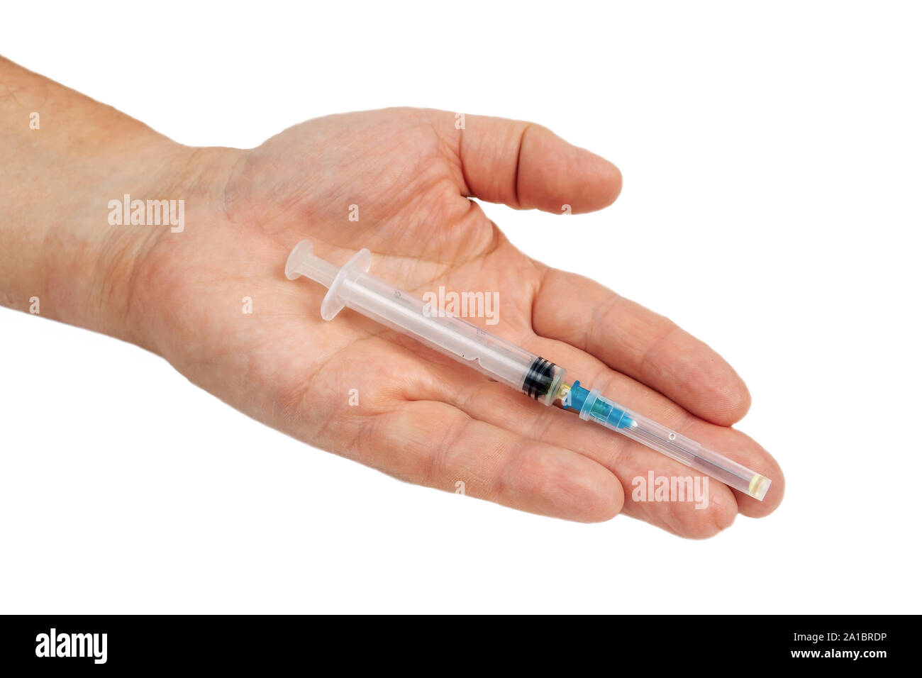 Hand holds medical syringe on white background Stock Photo - Alamy