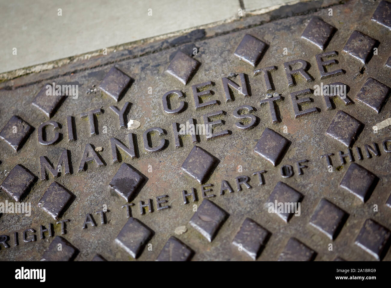 Manchester man-hole cover with City Centre Manchester embossed Stock ...