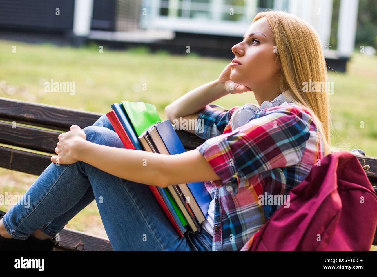 Exhausted and worried female student studying outdoor Stock Photo - Alamy