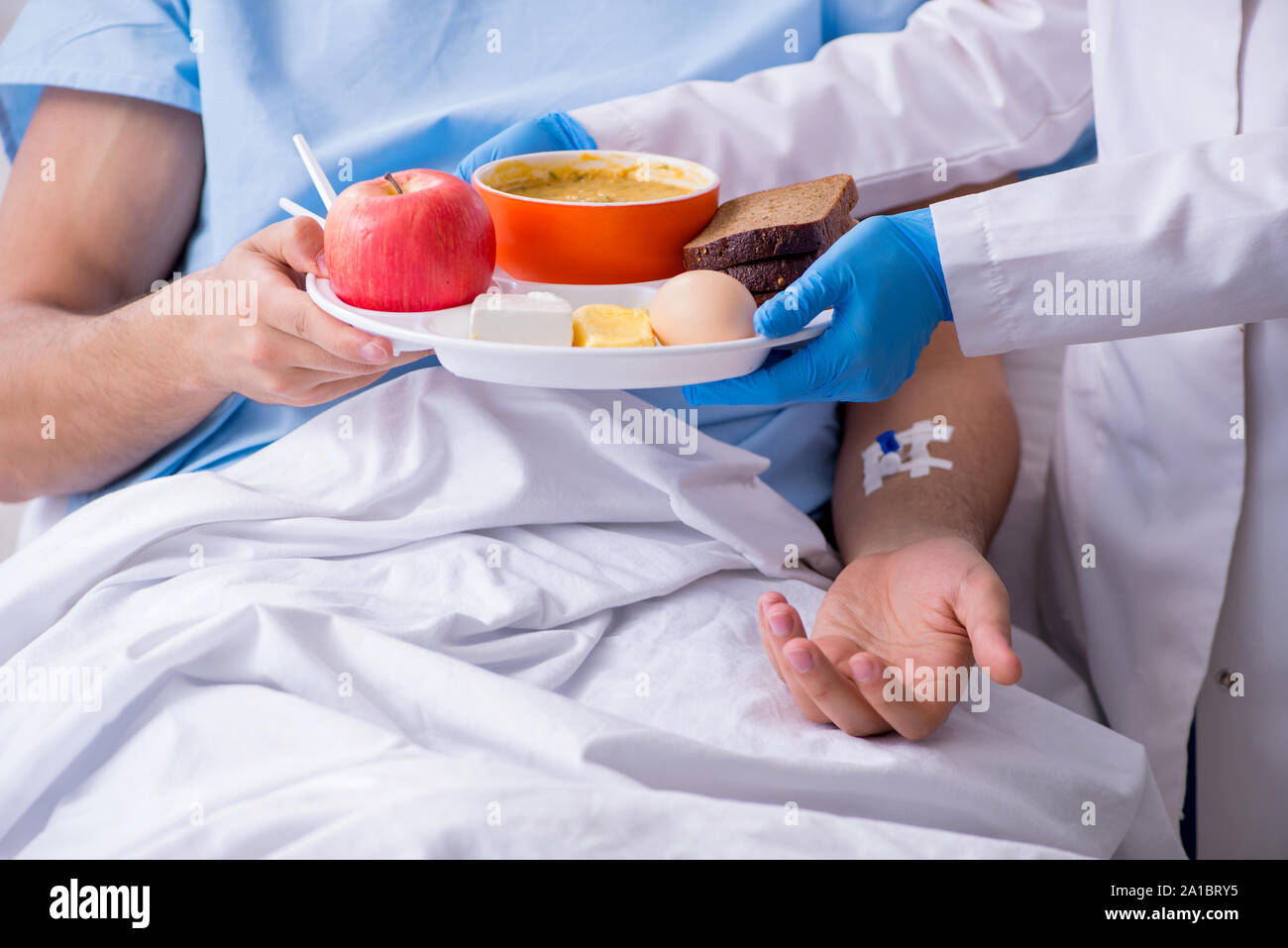 The male patient eating food in the hospital Stock Photo - Alamy